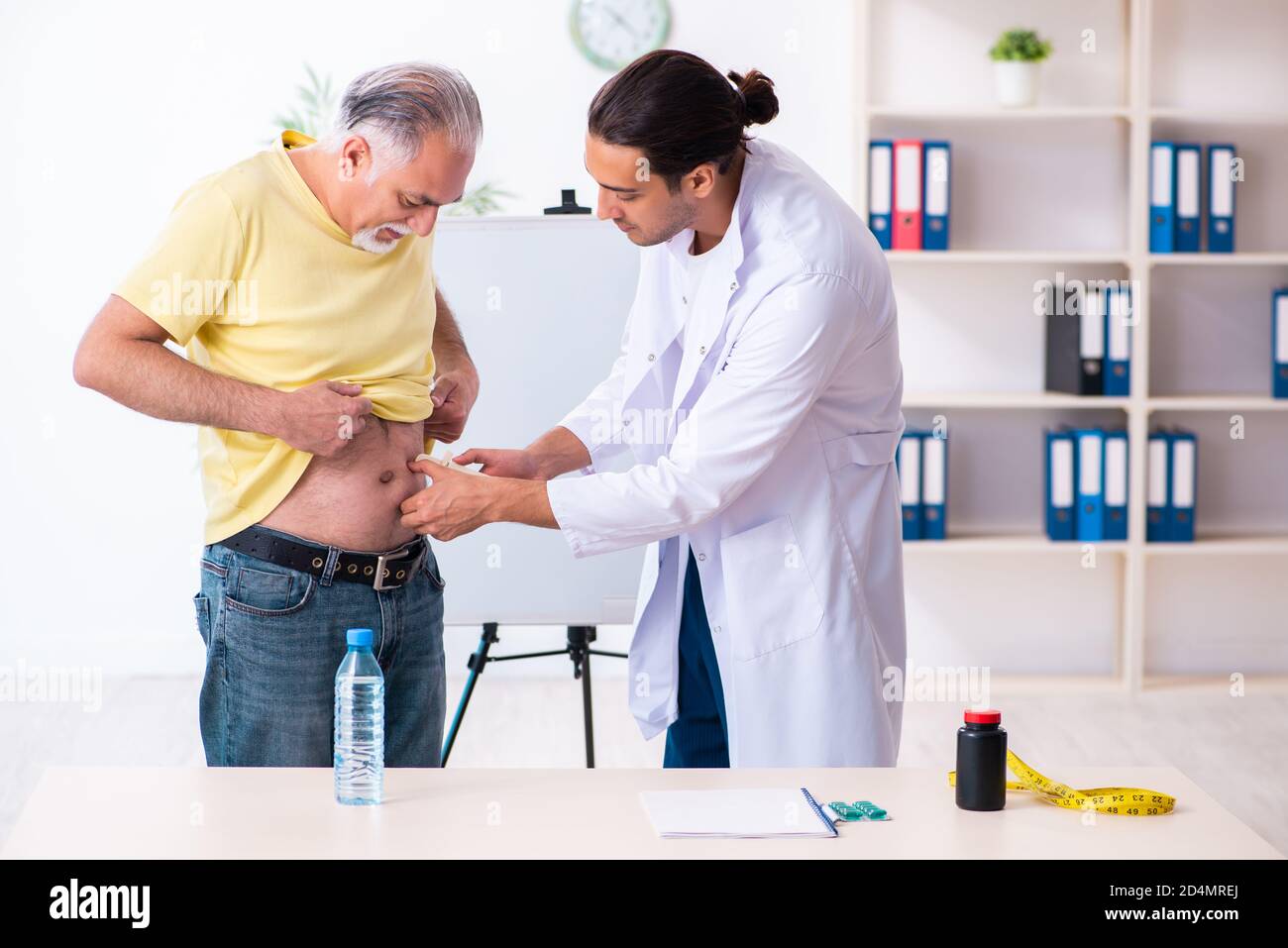 The doctor dietician giving advices to fat overweight patient Stock ...