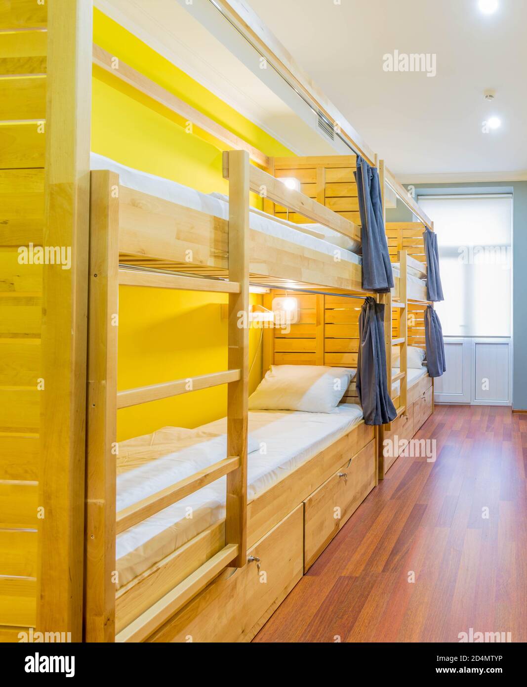 The hostel dormitory beds arranged in room Stock Photo - Alamy