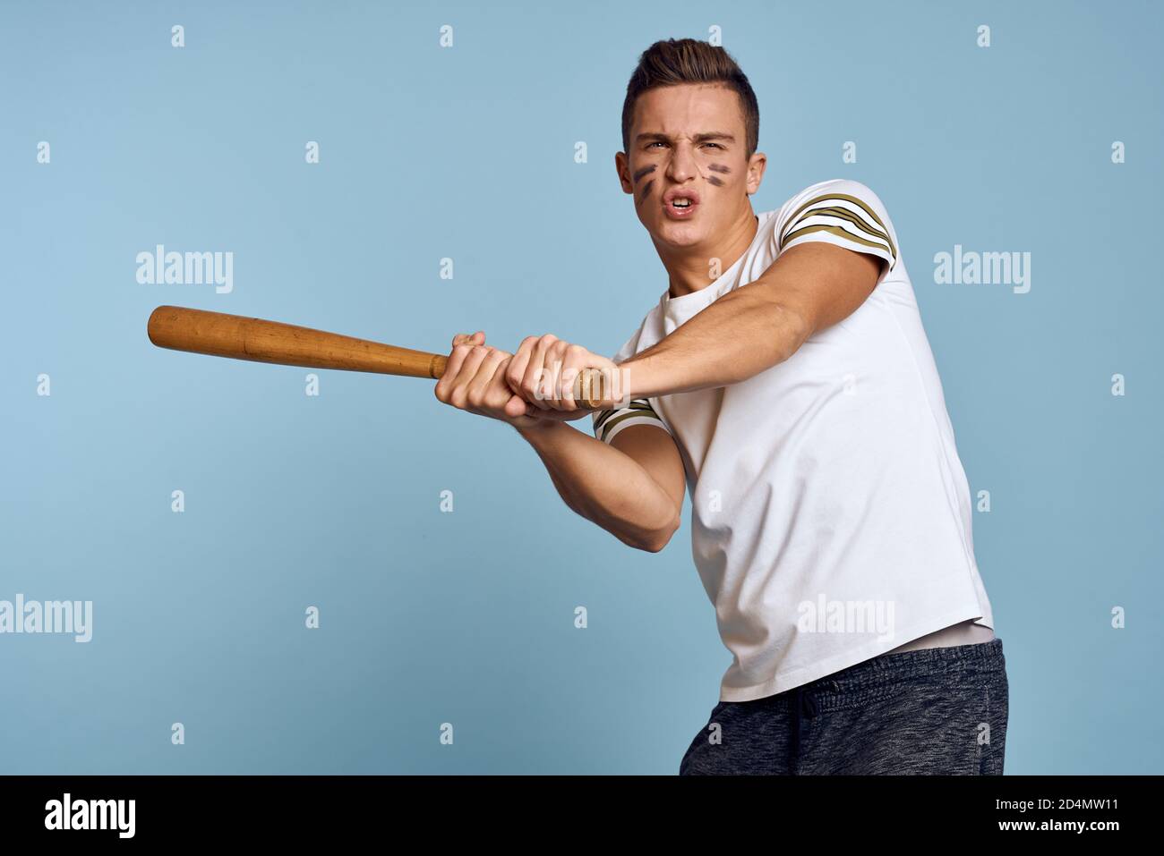 baseball guy with a bat in his hand on a blue background and a combat ...