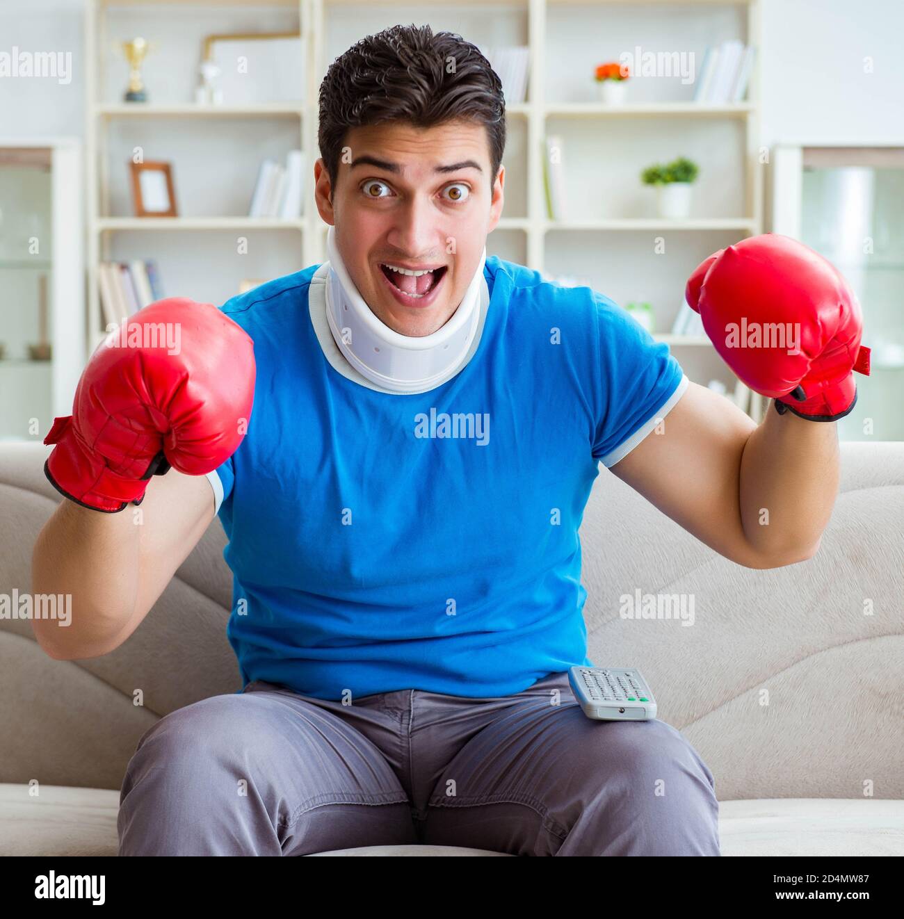 The man with neck injury watching boxing at home Stock Photo - Alamy