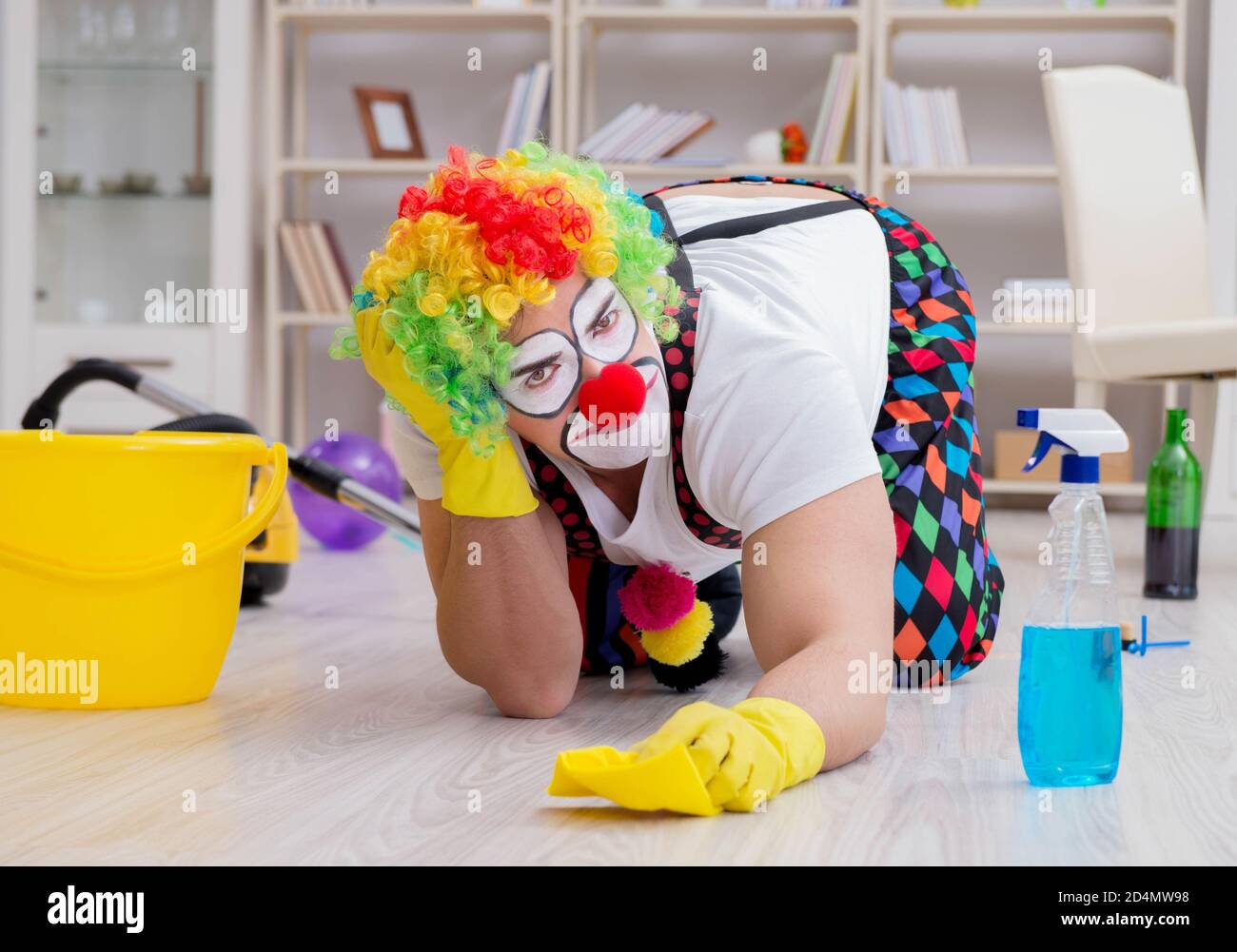 The funny clown doing cleaning at home Stock Photo - Alamy