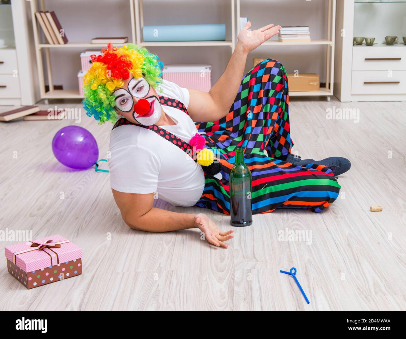 Drunk clown celebrating having a party at home Stock Photo - Alamy