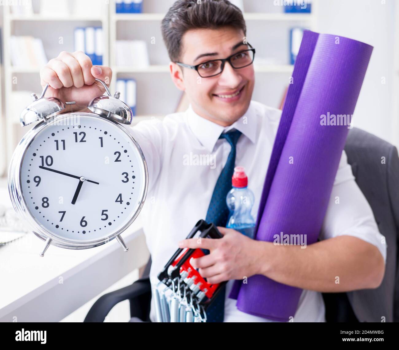 The businessman rushing to sports with clock Stock Photo - Alamy