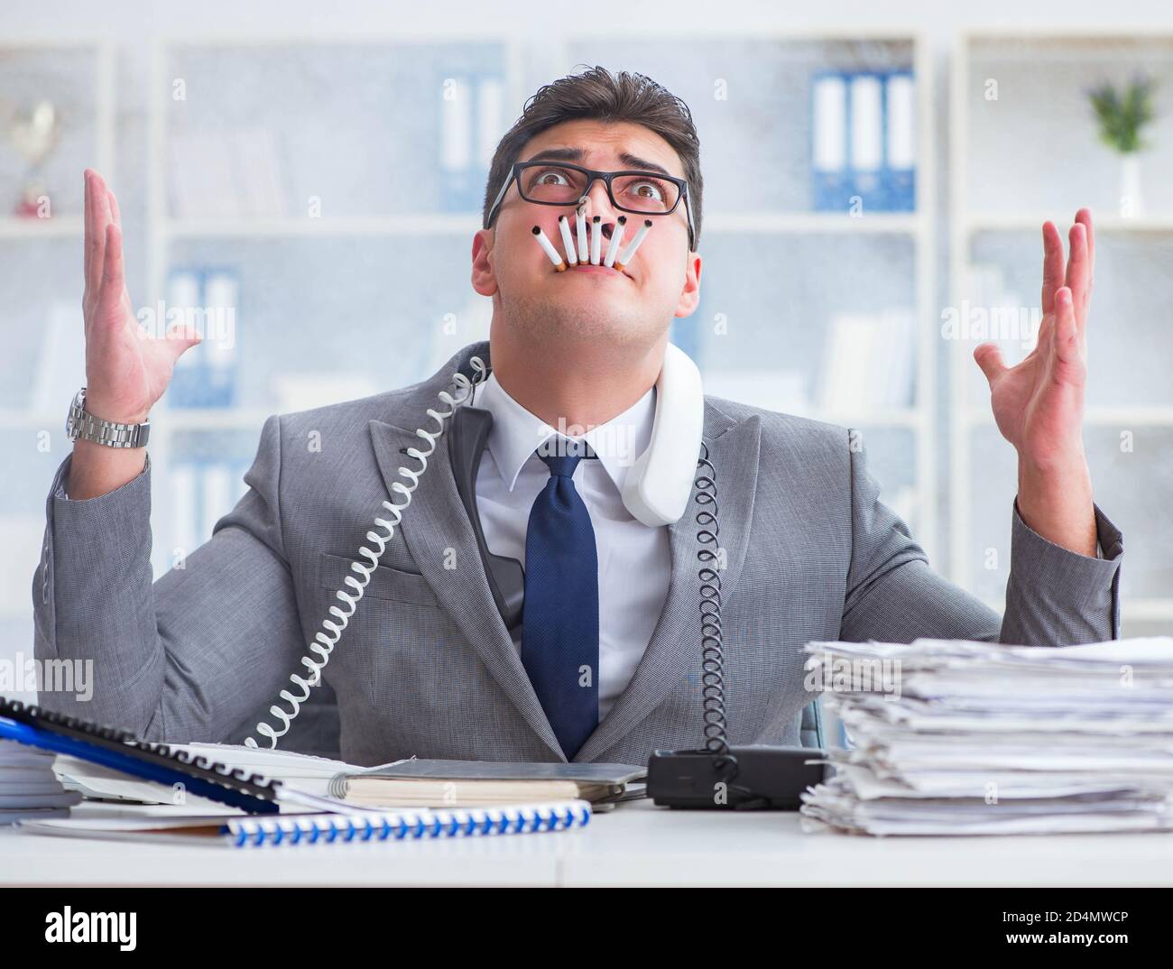 The businessman smoking in office at work Stock Photo - Alamy