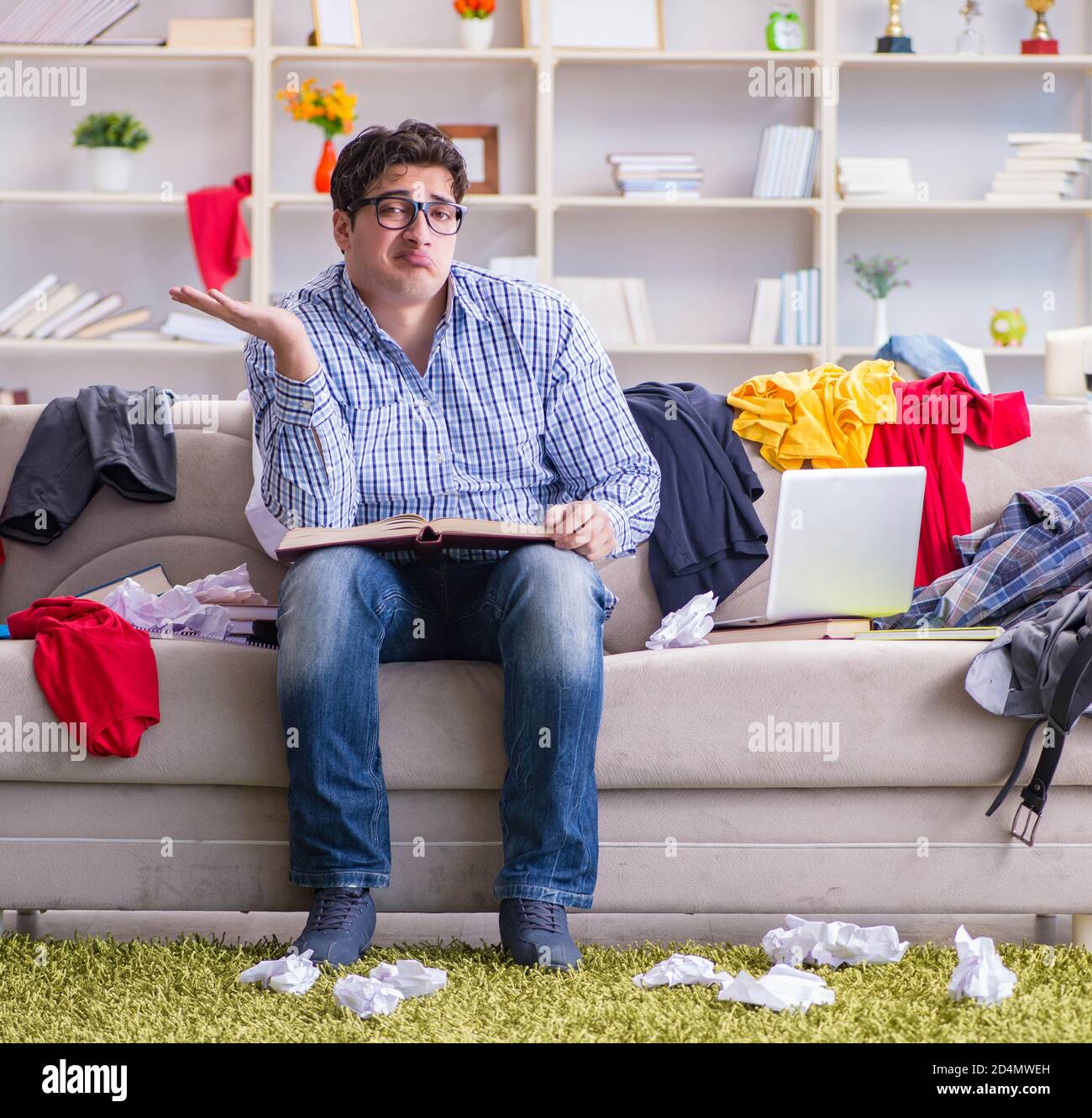 Young man working studying in messy room Stock Photo - Alamy