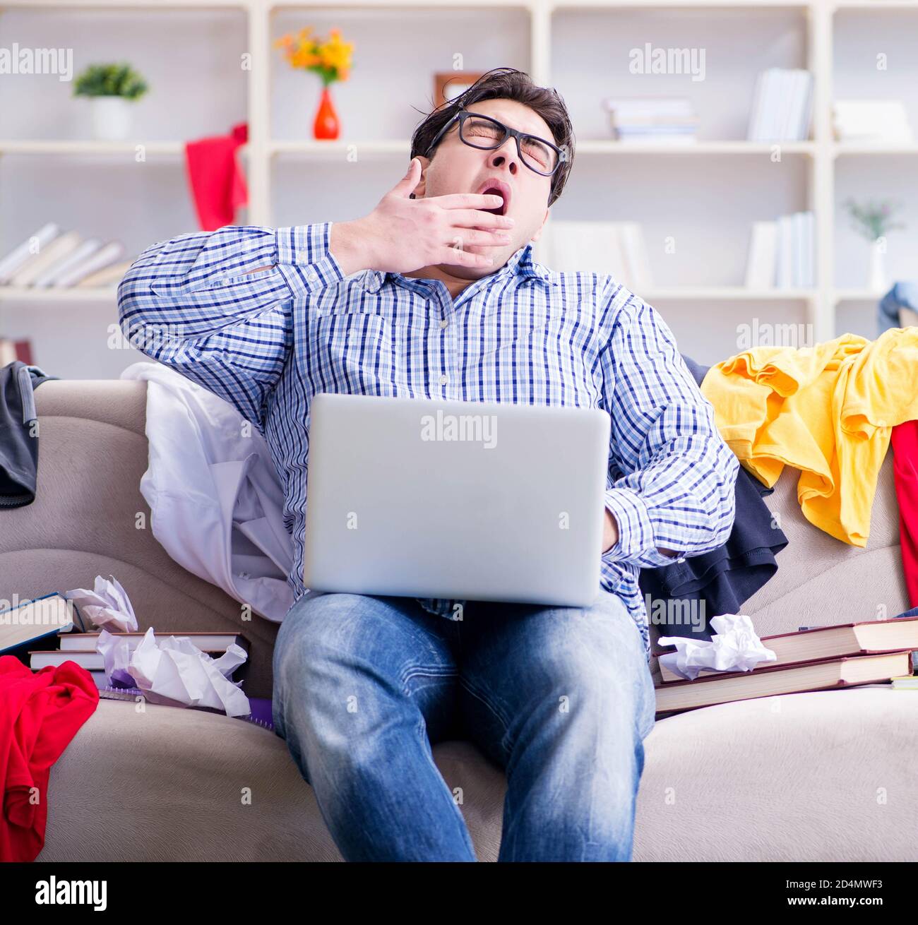 The young man working studying in messy room Stock Photo - Alamy