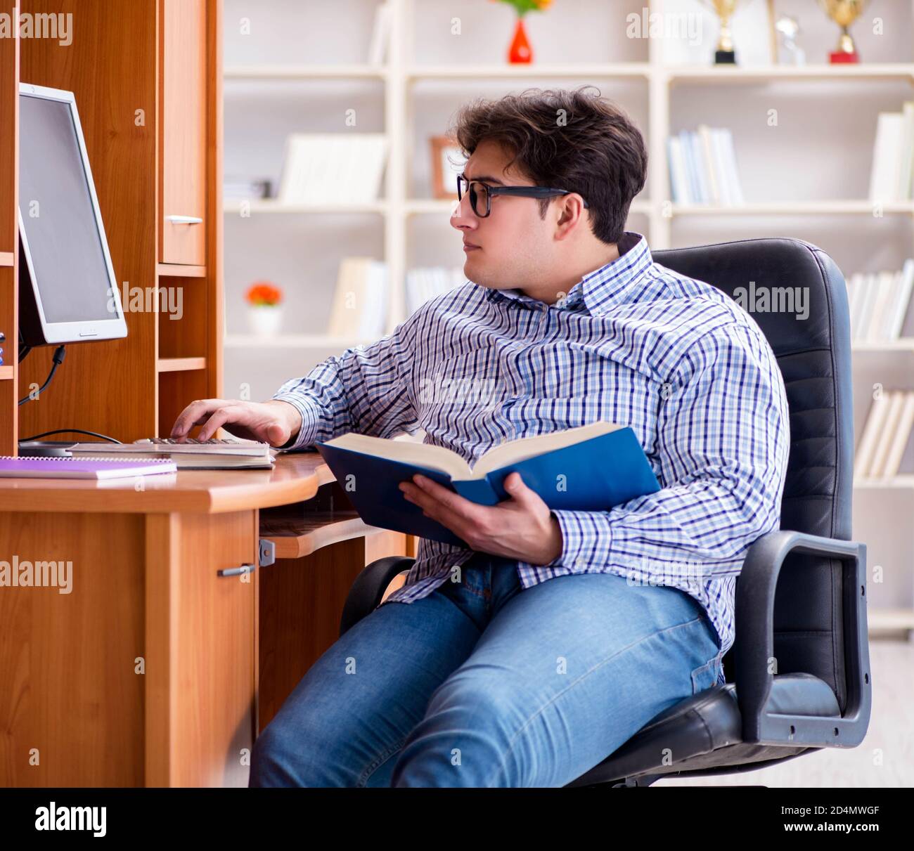 The young student at computer table Stock Photo - Alamy