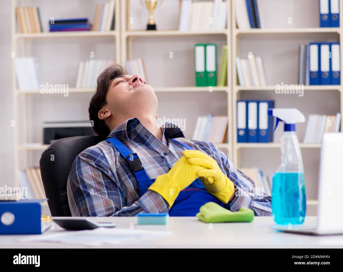 The male cleaner working in the office Stock Photo - Alamy