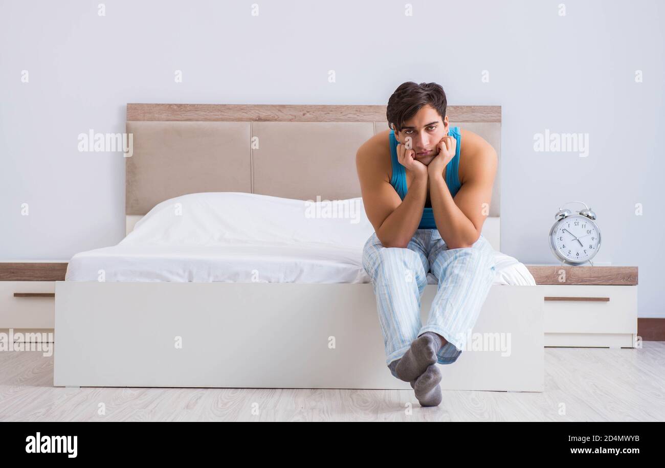 The young man waking up in bed Stock Photo - Alamy