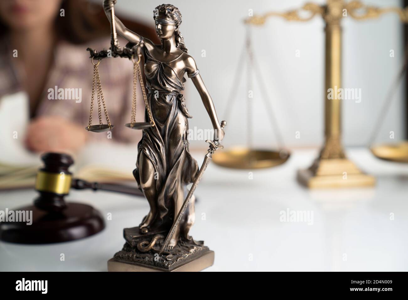 Female attorney at work. Judge's gavel and Themis statue on white desk ...