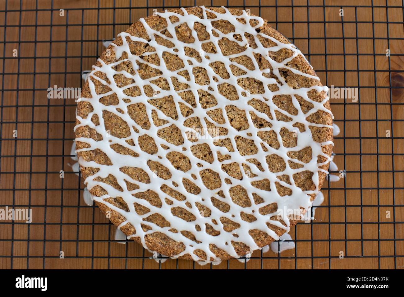 An almond cake with a grid of lemon icing on a cooling rack Stock Photo ...