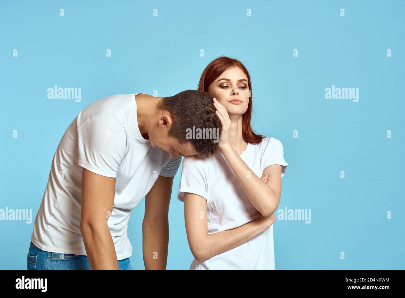 Young woman and man stinks relationship on blue background cropped view ...