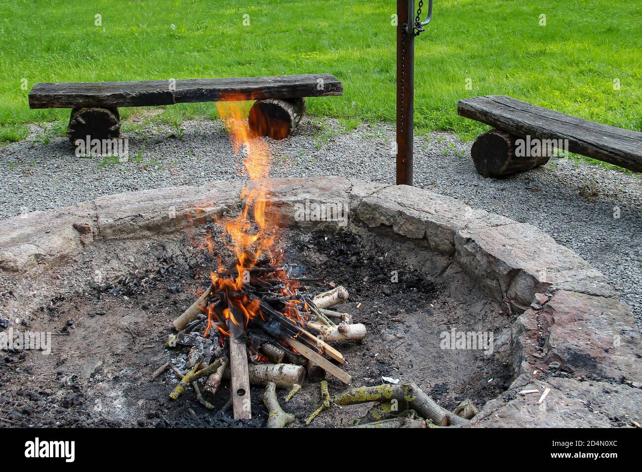 Bonfire in a park surrounded by empty benches Stock Photo - Alamy
