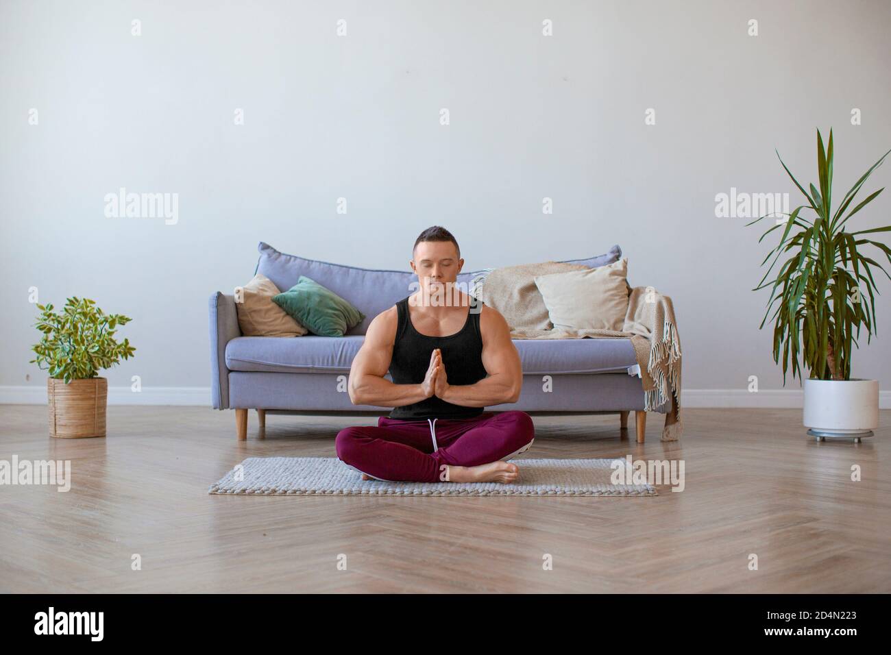 Strong man practicing yoga at home. Meditation and calmness. Healthy ...