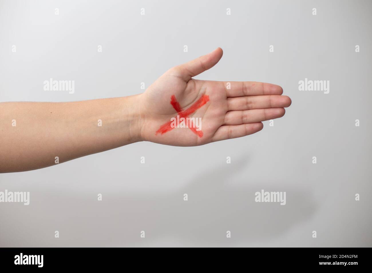 Hand with a red X sign isolated on a white background Stock Photo - Alamy