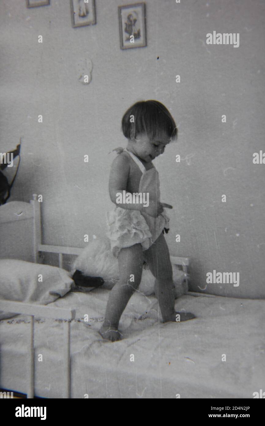 Fine 1970s vintage black and white photography of a little girl playing ...