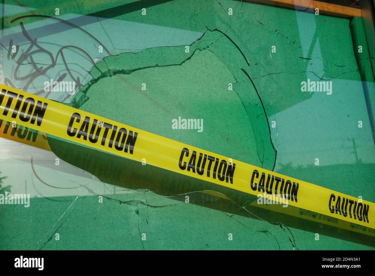 Broken shop window with a safety caution tape in front of it Stock ...