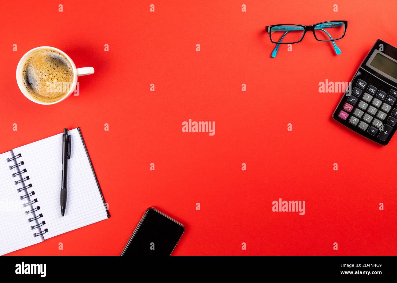 Flat lay of the office working tools on the red surface - space for ...