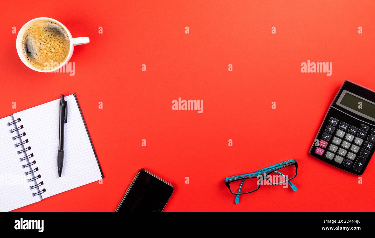 Flat lay of the office working tools on the red surface - space for ...