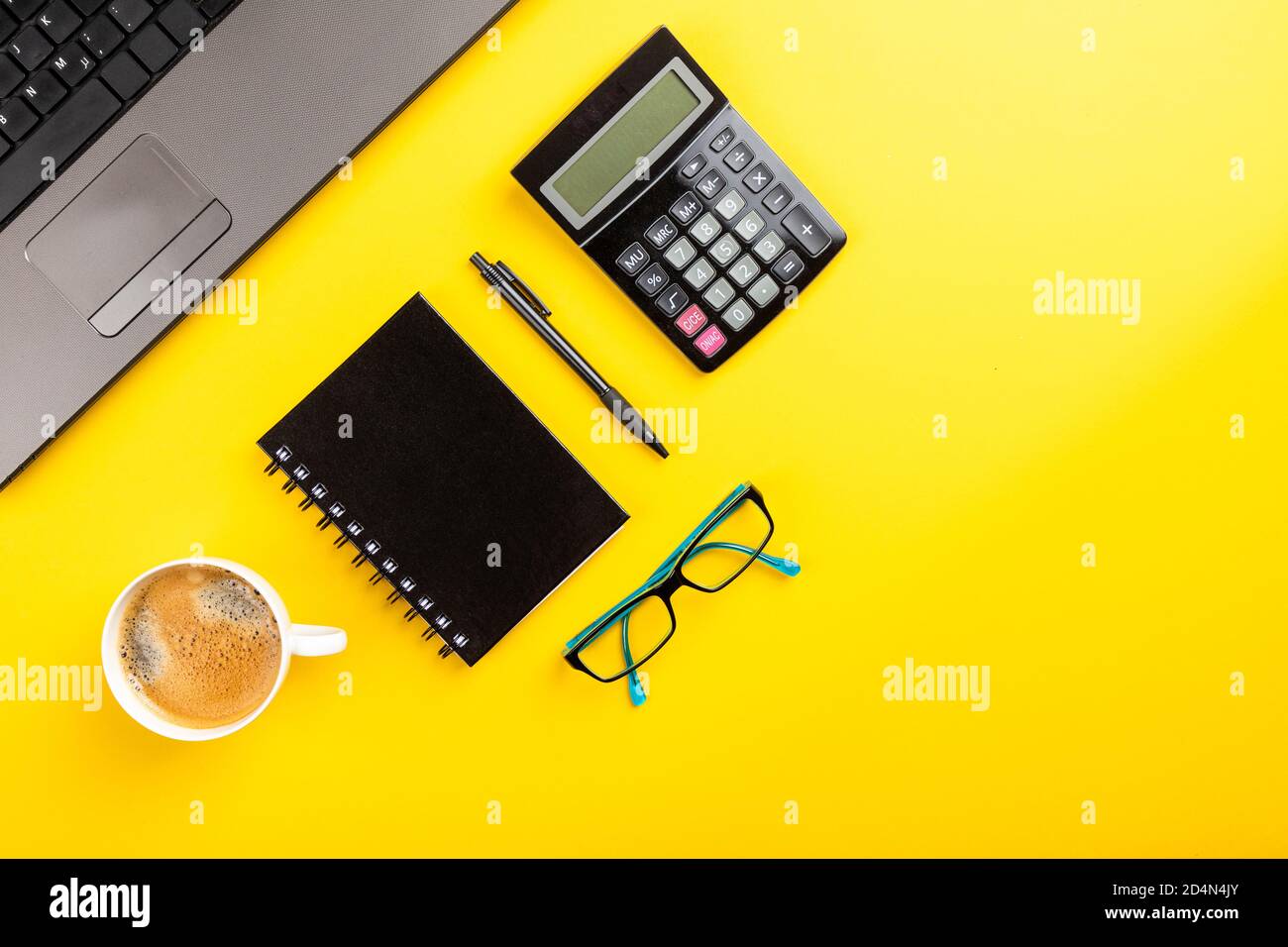 Flat lay of the office working tools on the yellow surface - space for ...