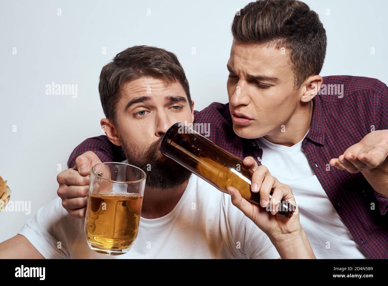 Two friends drink beer leisure fun alcohol friendship lifestyle light ...