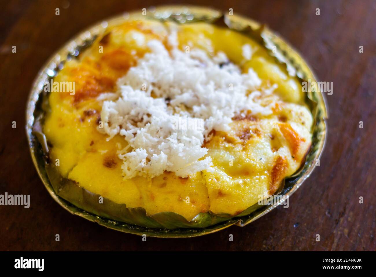 Glutinous rice cake locally called bibingka and topped with freshly ...