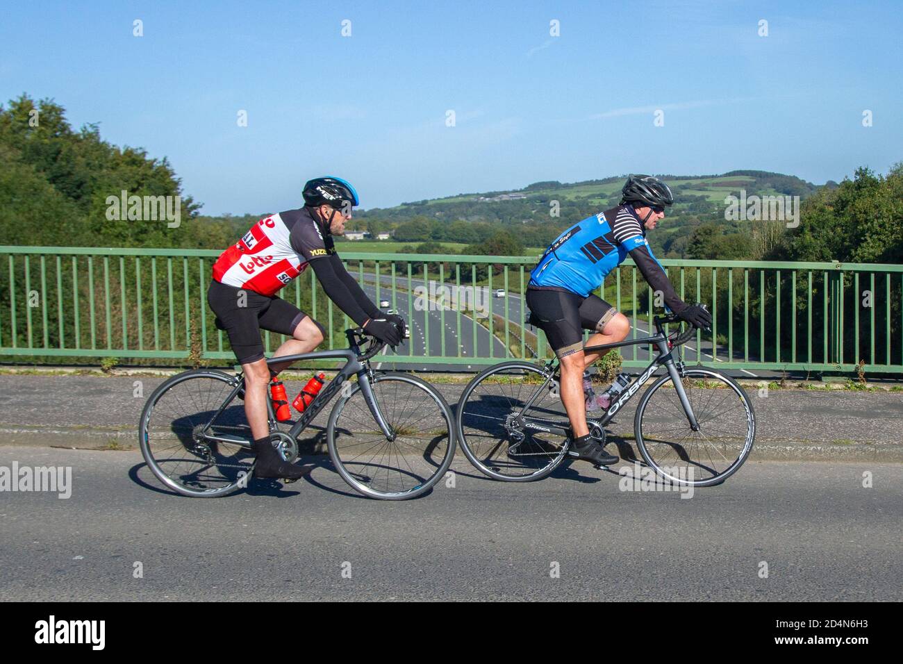 Male cyclists riding Oreba & Basso carbon fibre sports road bike on ...