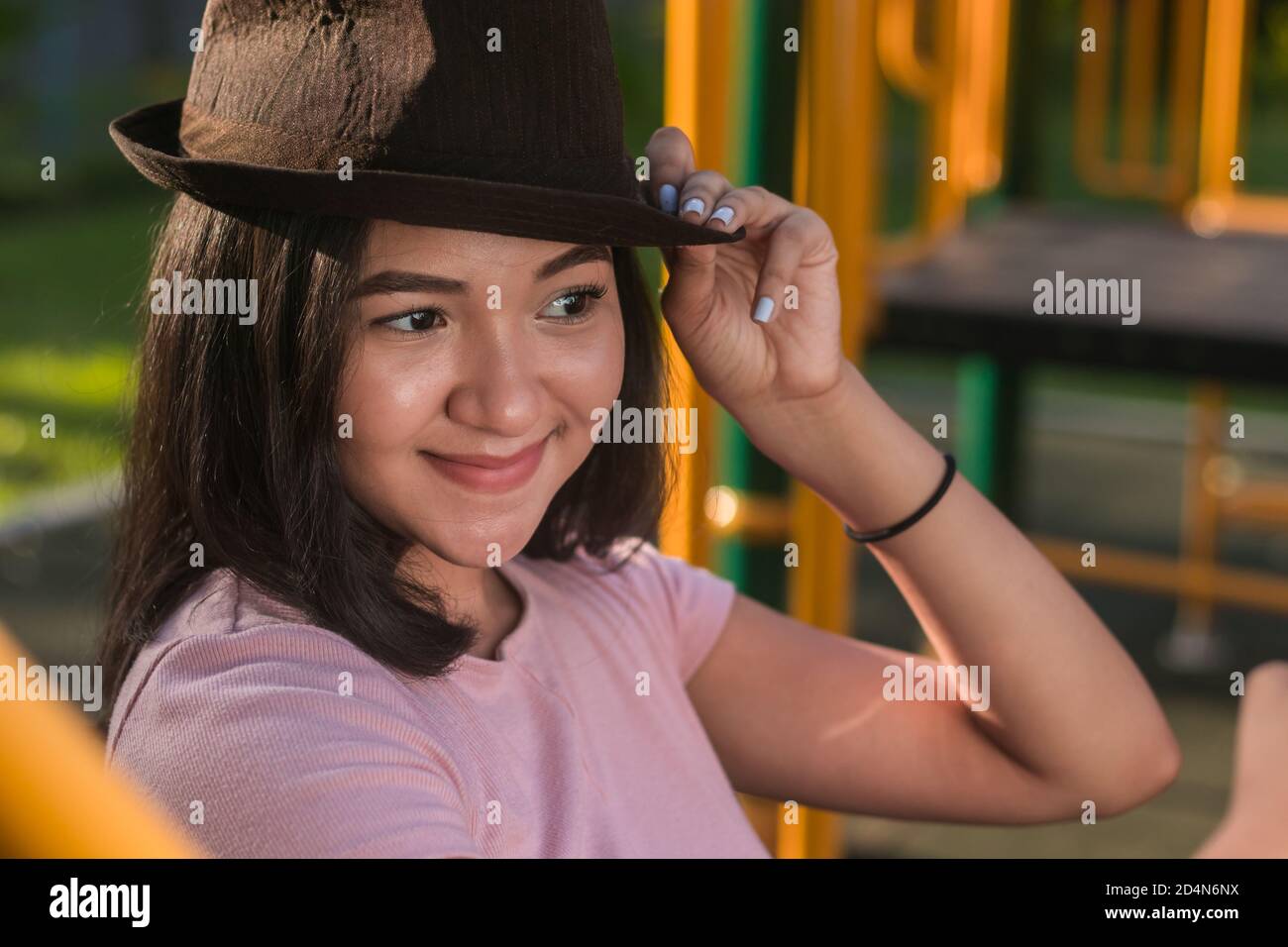 Latin lady wearing a hat smiling and doing a selfie Stock Photo - Alamy