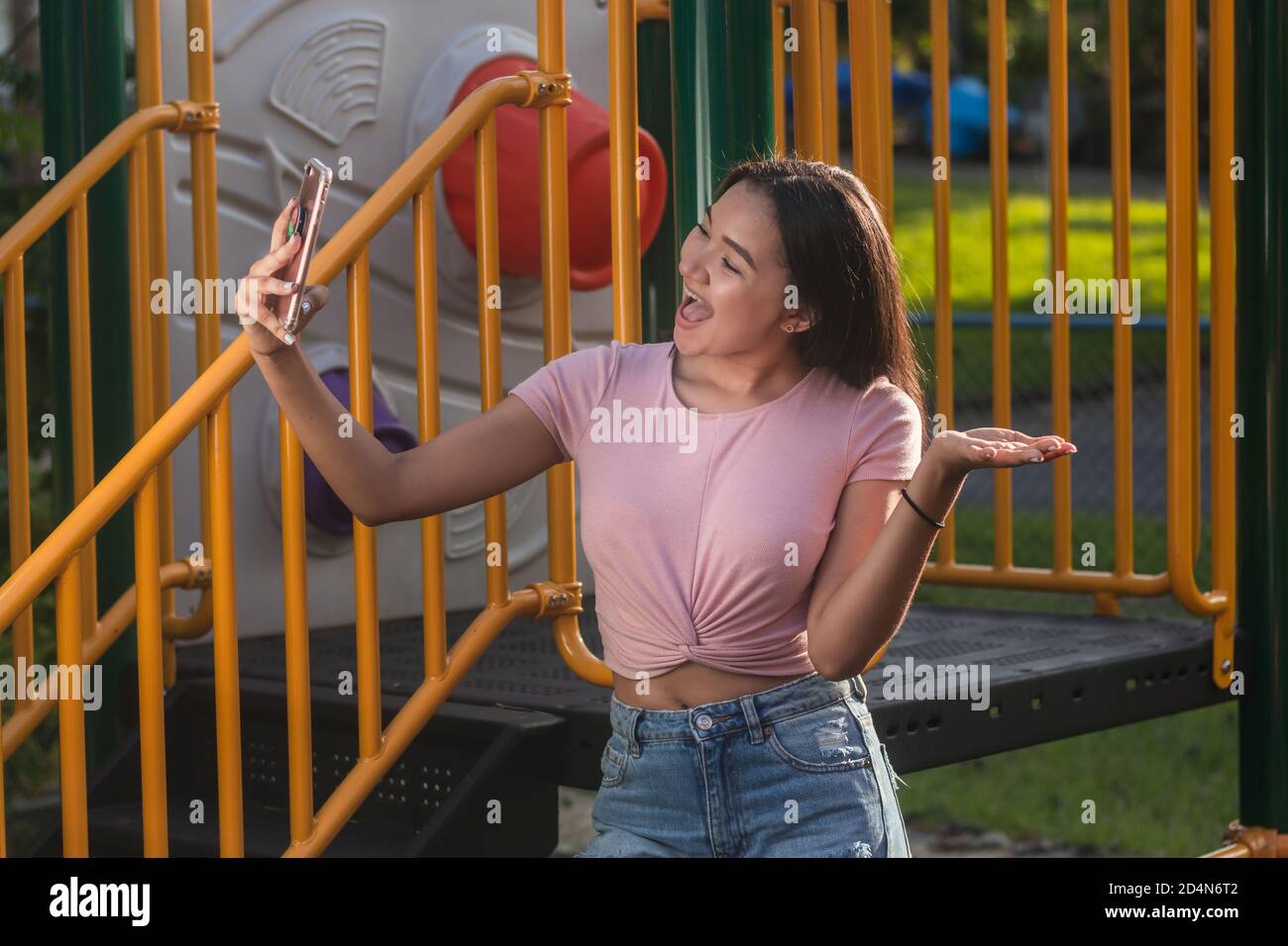 Latin young lady doing a selfie with a happy face in the playground ...