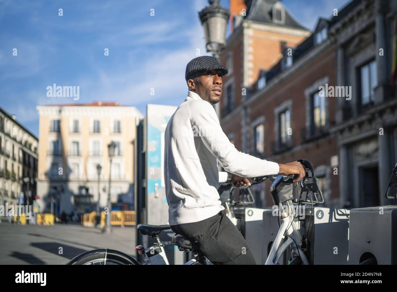 African-African man taking a public bicycle to ride Stock Photo - Alamy