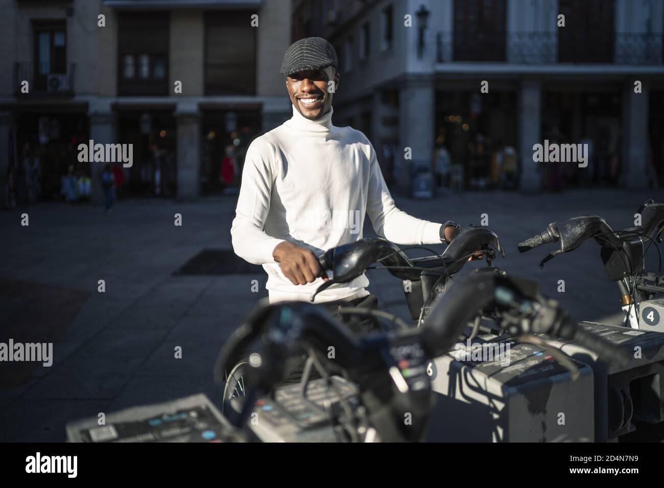 African-African man taking a public bicycle to ride Stock Photo - Alamy