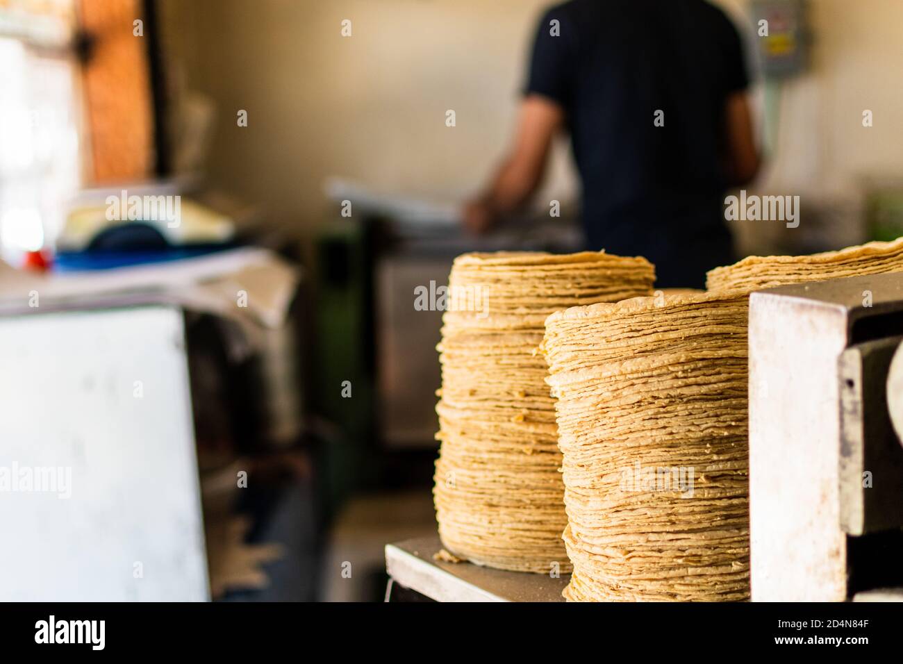 Mexican male preparing tortilla bread in his shop Stock Photo - Alamy