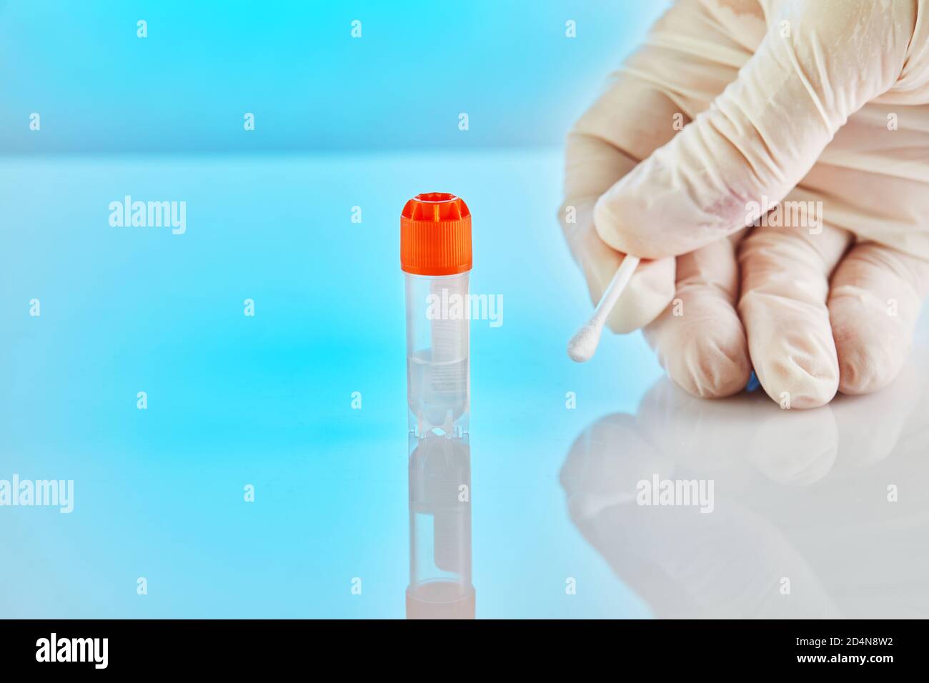 DNA test. Test tube with liquid for DNA analysis and a gloved hand ...