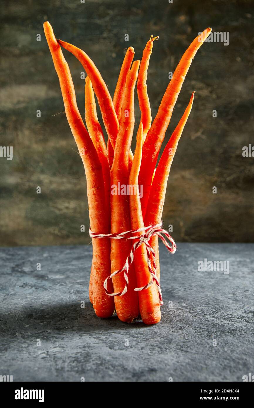 Ugly food. Deformed organic carrots on a blue background. Deformed ...