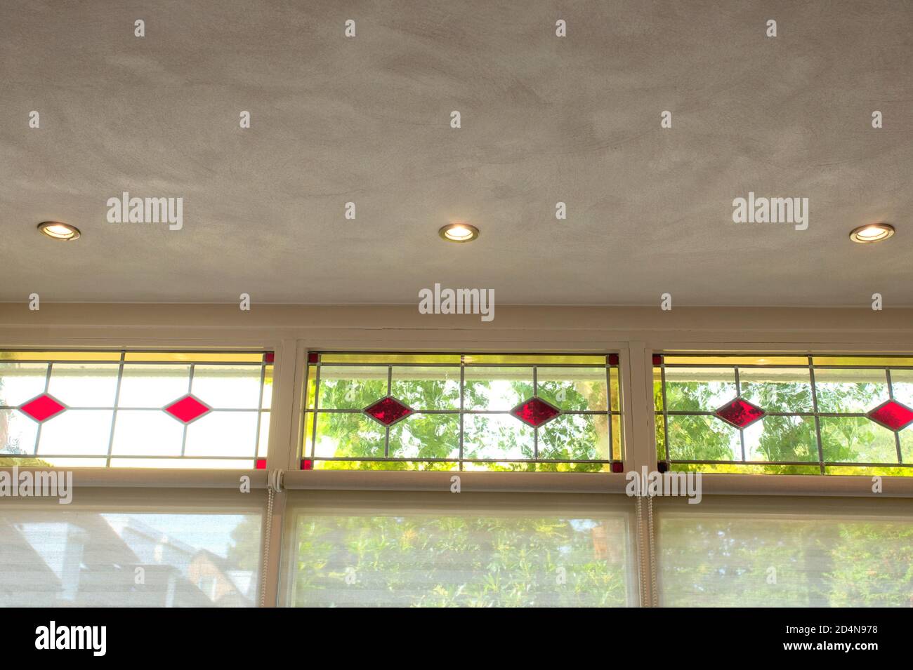 closeup of stained glass windows with red and yellow sections in a cozy ...