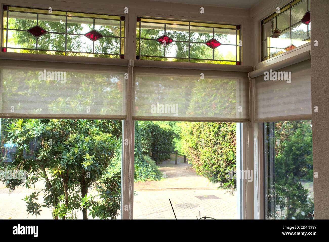 closeup of stained glass windows with red and yellow sections in a cozy ...