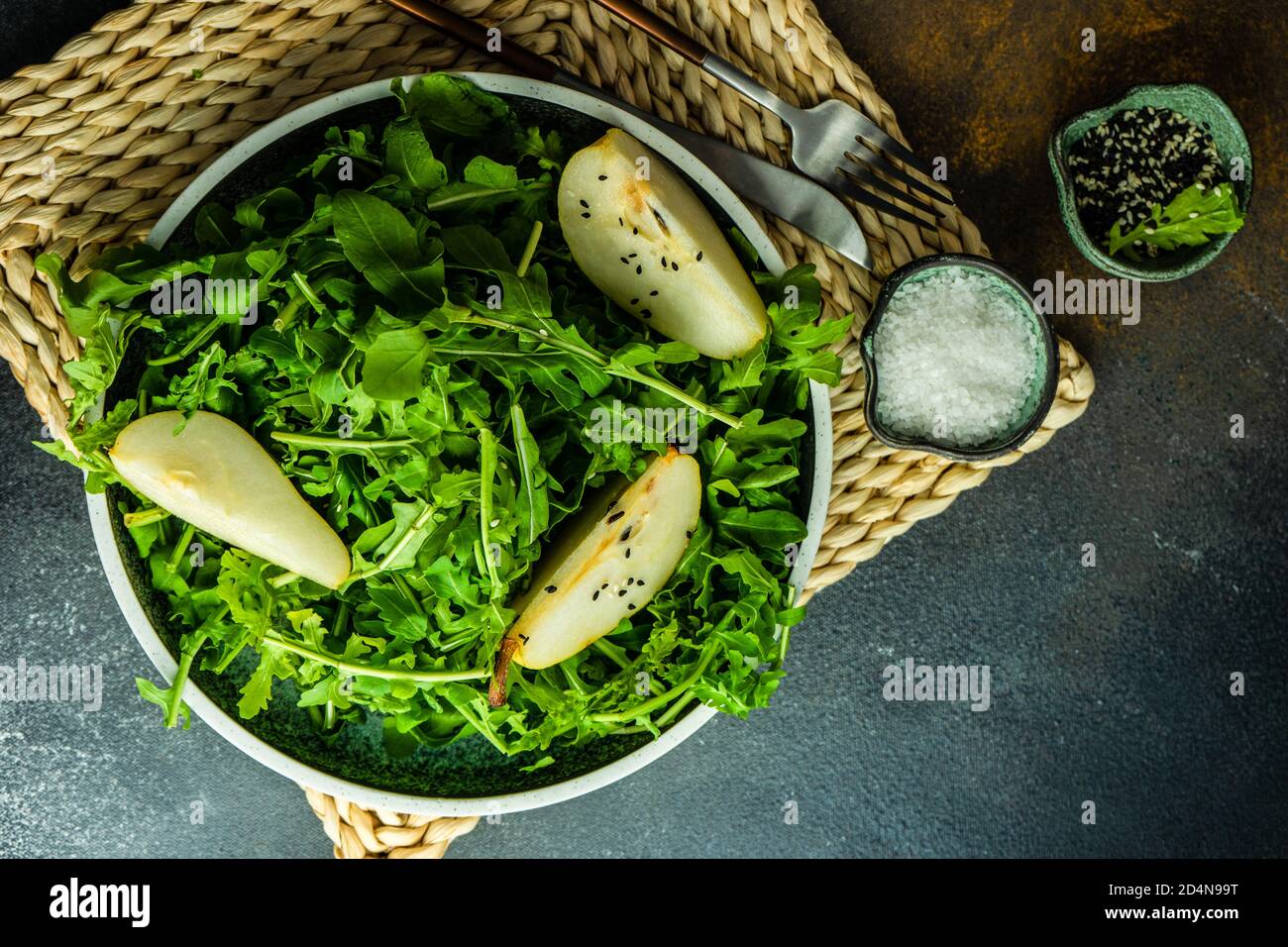 Organic food concept with fresh raw rucola leaves and pear slices with ...