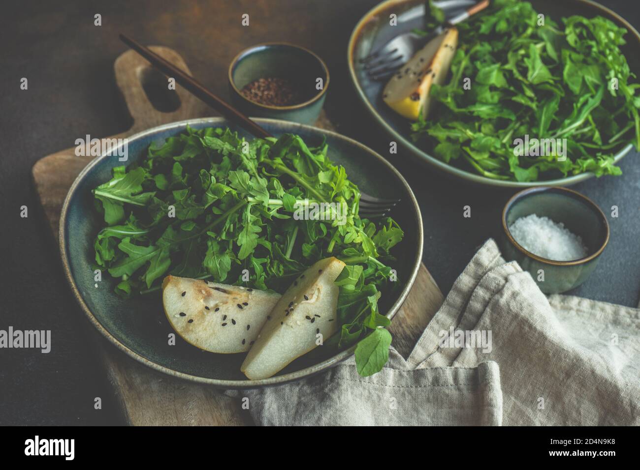 Organic food concept with fresh raw rucola leaves and pear slices with ...
