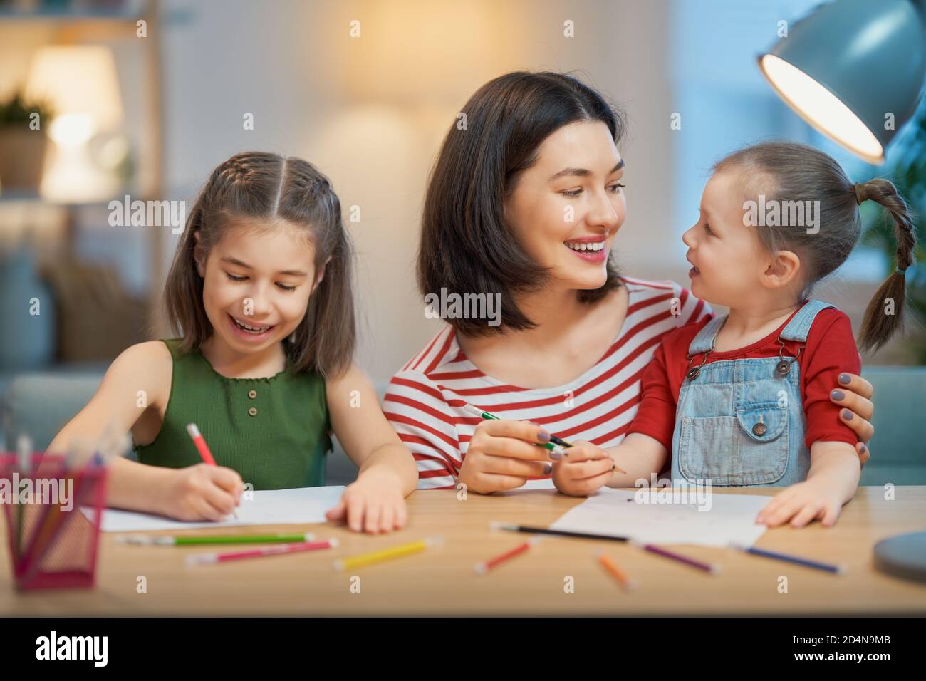 Back to school. Happy child is sitting at desk. Girl doing homework ...