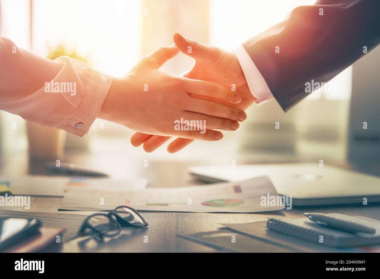 Man and woman are shaking hands in office. Collaborative teamwork Stock ...