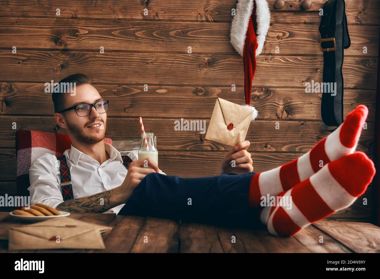 Merry Christmas and Happy Holidays! Handsome man with Santa symbol ...