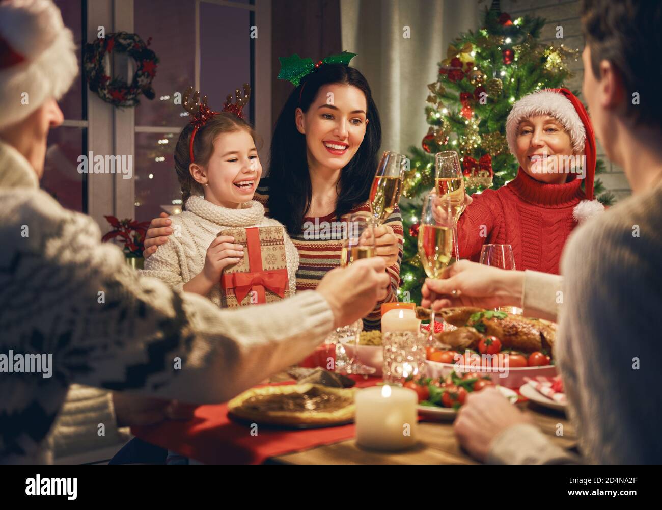 Merry Christmas! Happy family are having dinner at home. Celebration holiday and togetherness ...