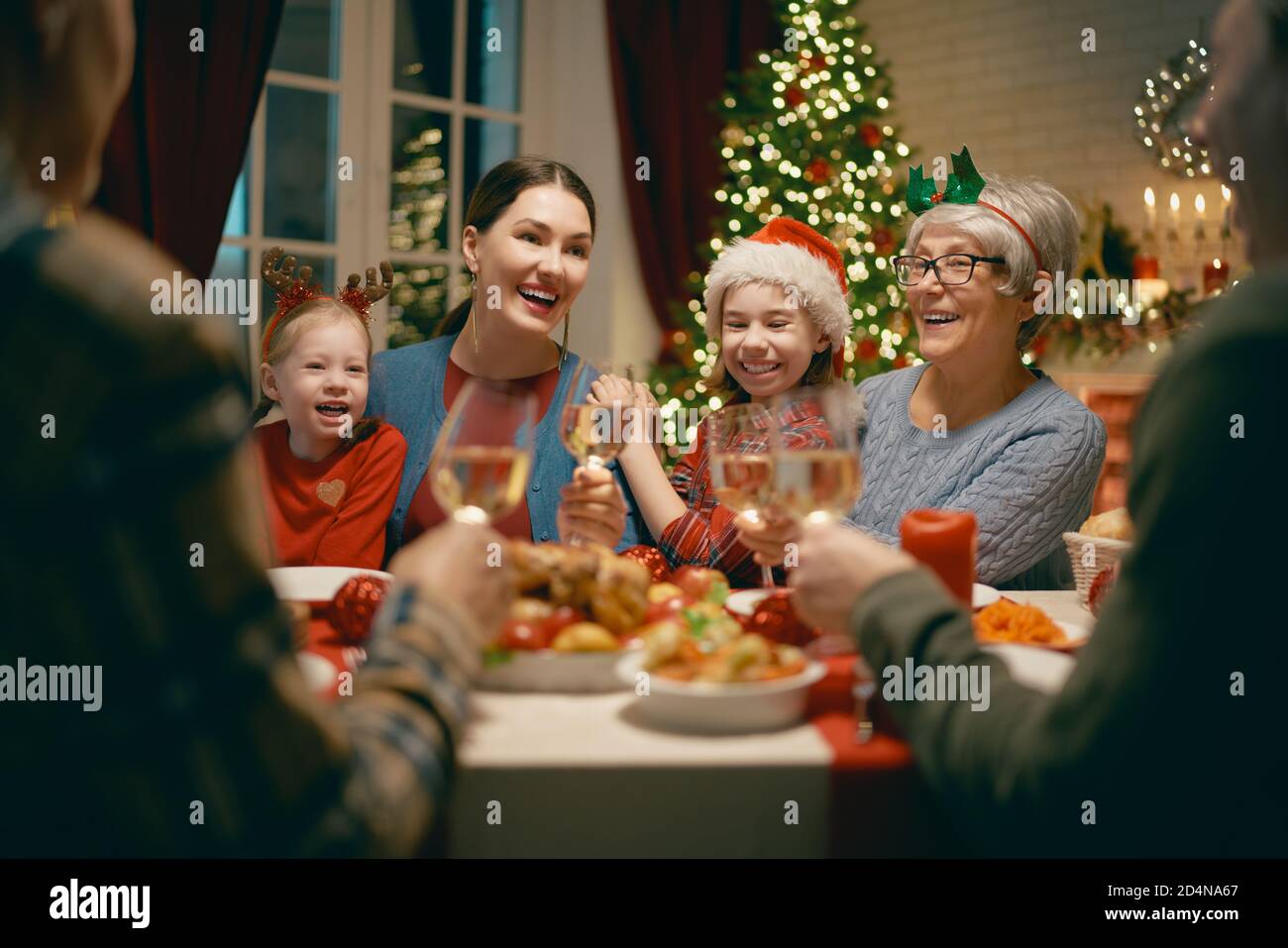 Merry Christmas! Happy family are having dinner at home. Celebration holiday and togetherness ...