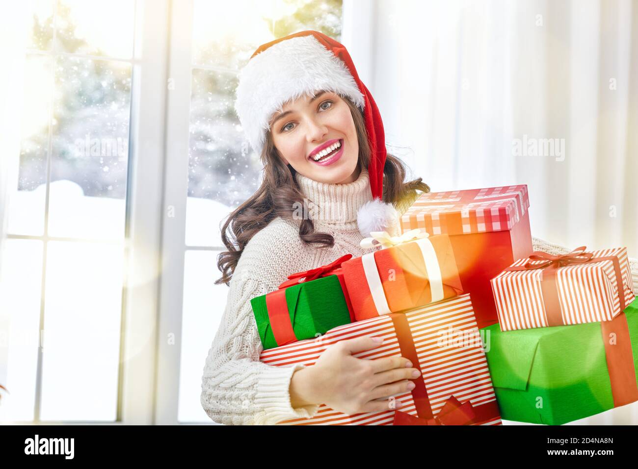 Beautiful young woman with gift boxes Stock Photo - Alamy