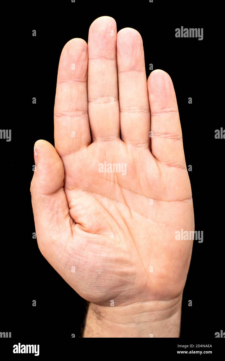 male open hand with fingers pressed to each other on a black background ...