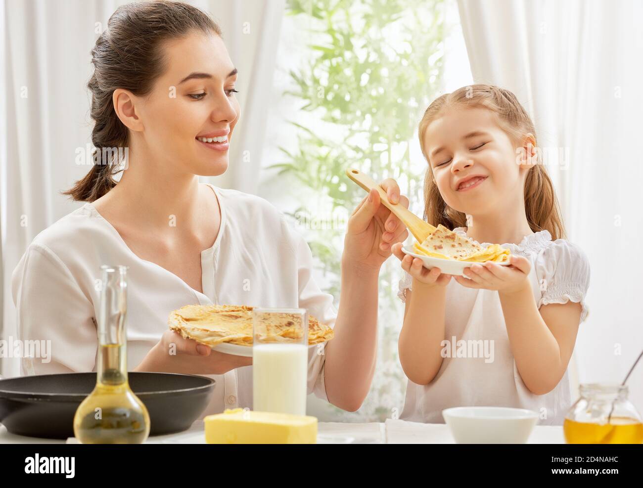 mother and daughter prepare pancakes Stock Photo - Alamy