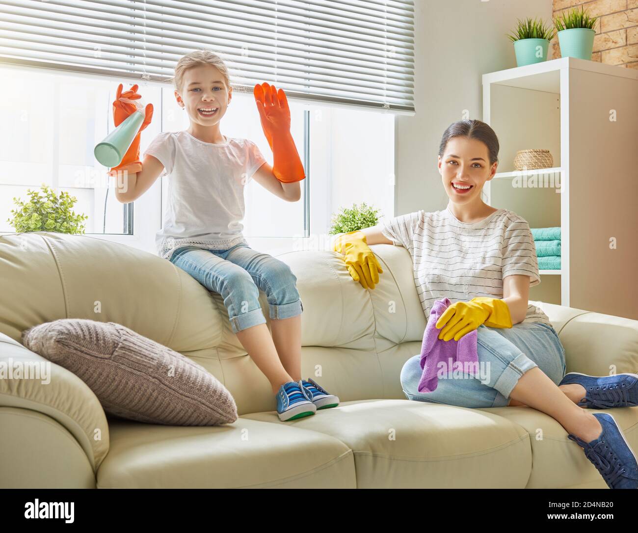 Happy family cleans the room. Mother and daughter do the cleaning in ...