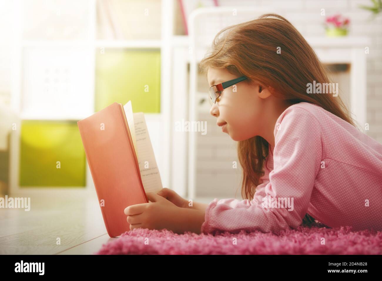 cute child girl reading a book. self learning Stock Photo - Alamy