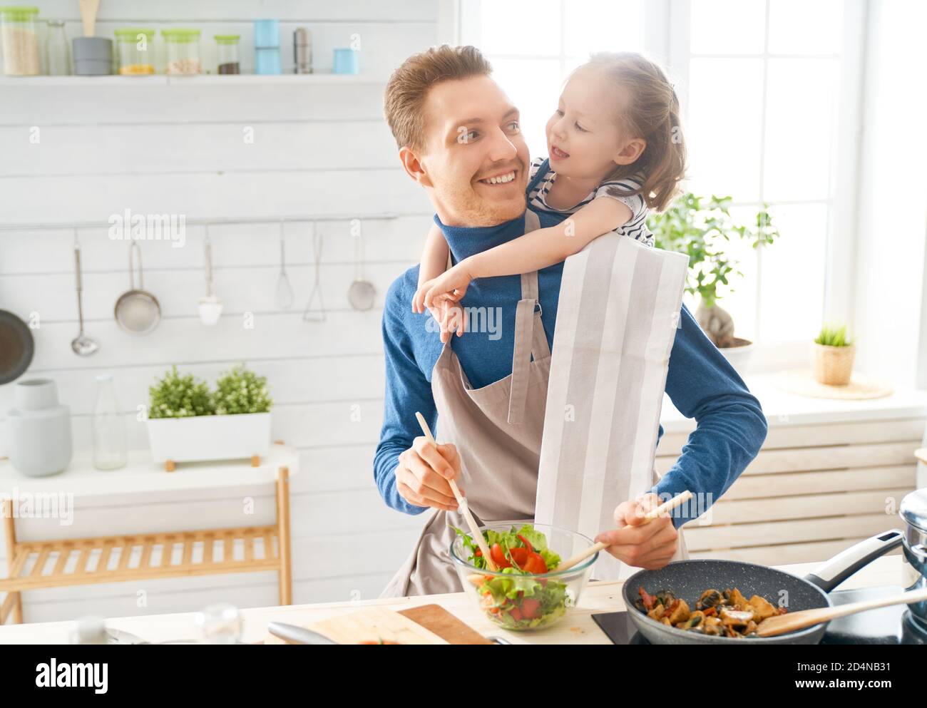 Healthy food at home. Happy family in the kitchen. Father and child ...