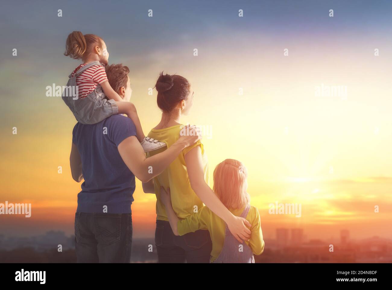 happy family at sunset. father, mother and two children daughters ...